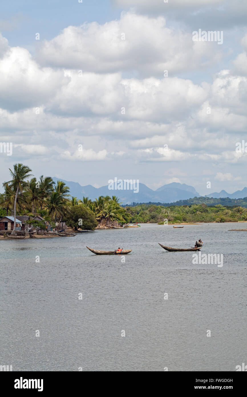 Sambava Bay. Encamped fishing community. Boys using dugout canoes to ...