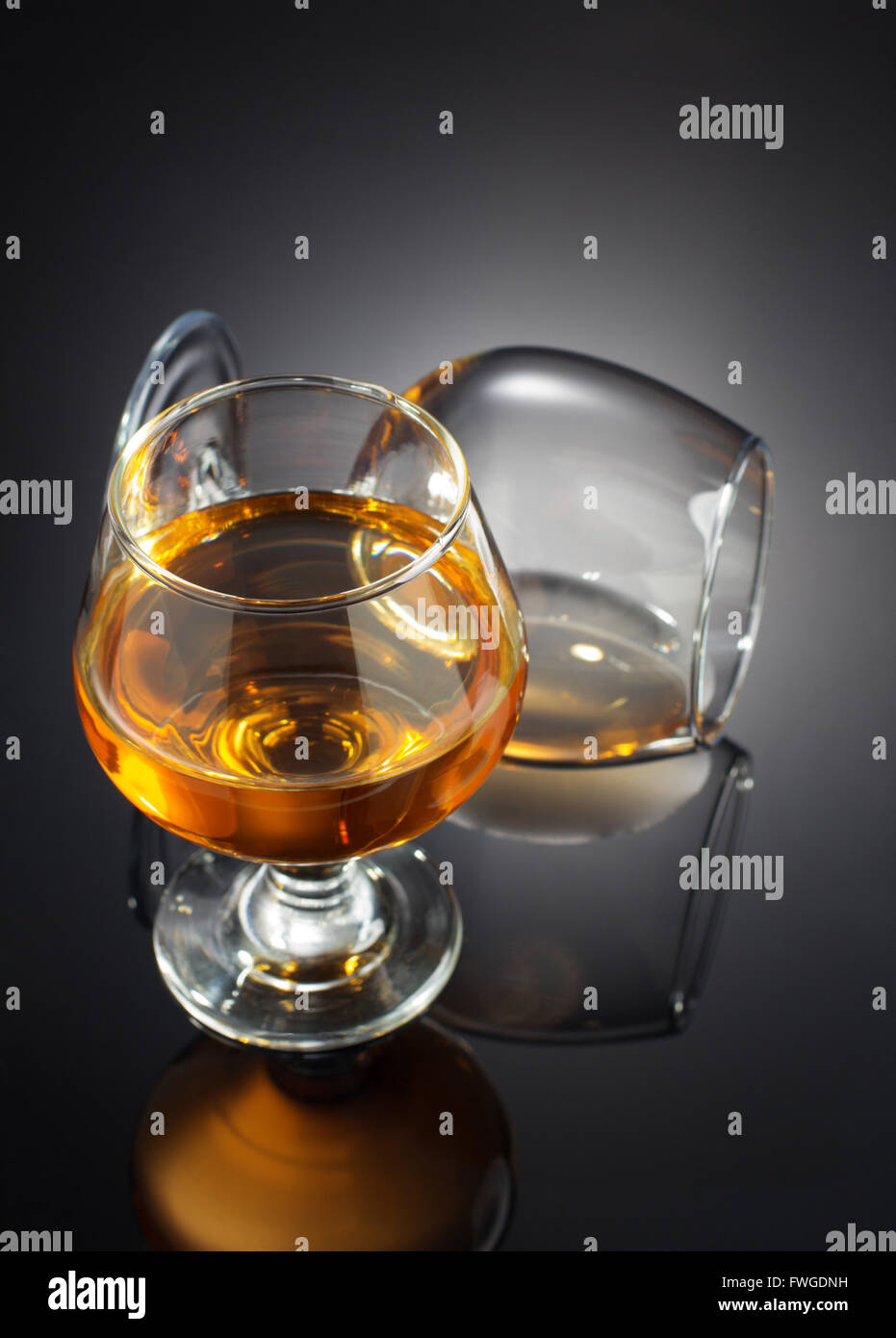 brandy in glass on black background Stock Photo - Alamy