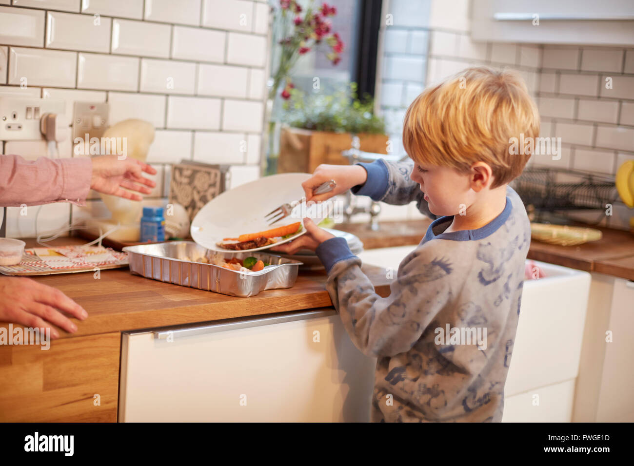 A boy clearing a plate after a meal Stock Photo - Alamy