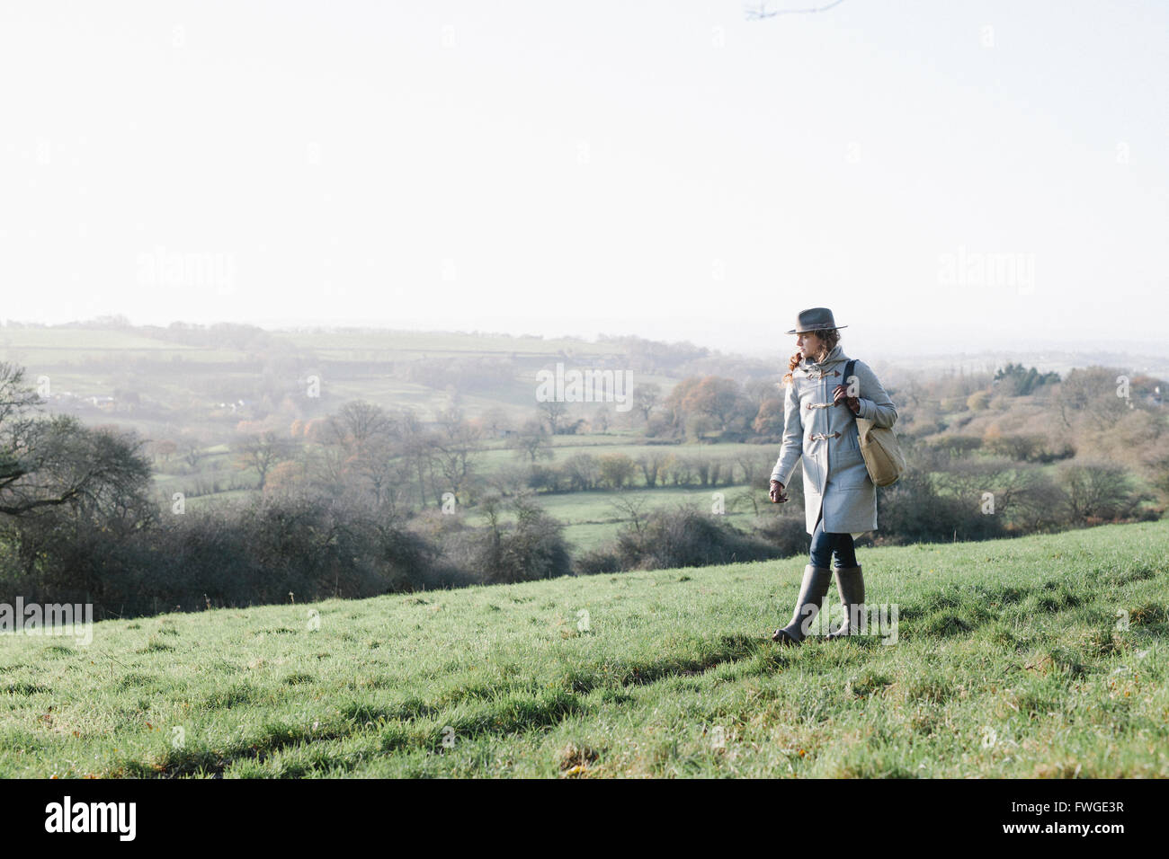 A woman walking on high ground overlooking the countryside Stock Photo ...