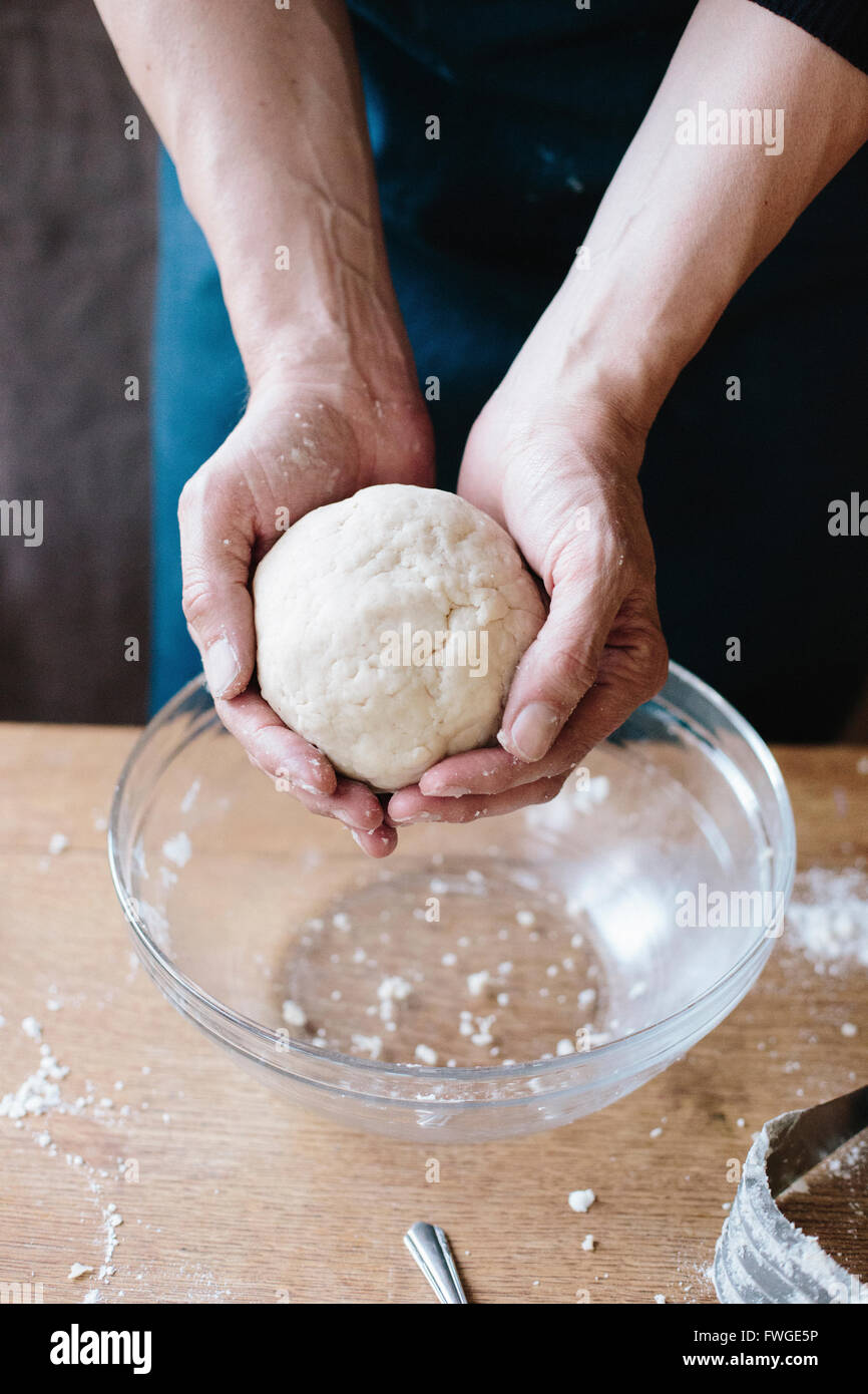 A man baking, holding pastry dough in his hands Stock Photo - Alamy