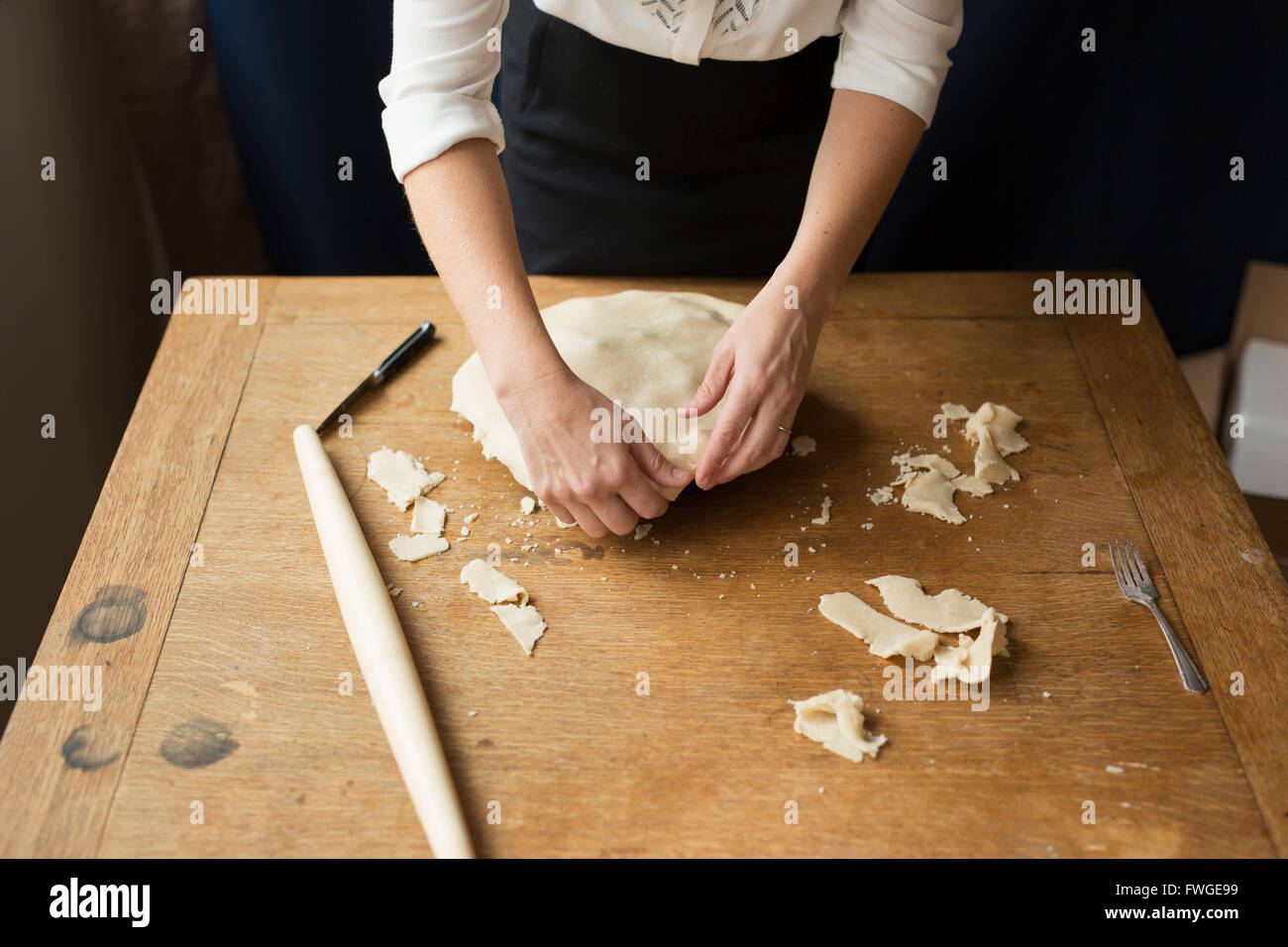 A woman crimping the pastry edge of a home made pie Stock Photo - Alamy