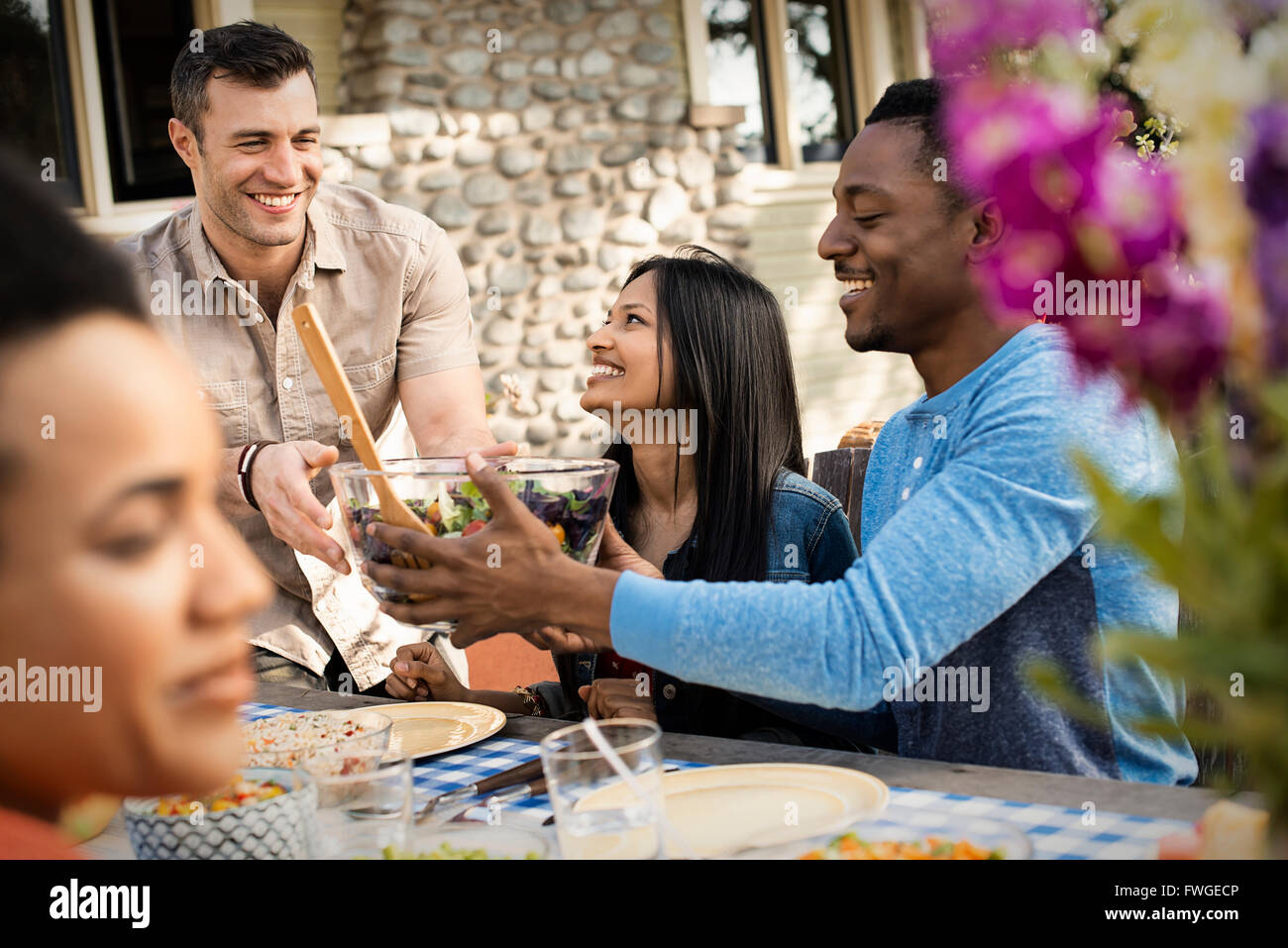 Laughing group of friends table hi-res stock photography and images - Alamy