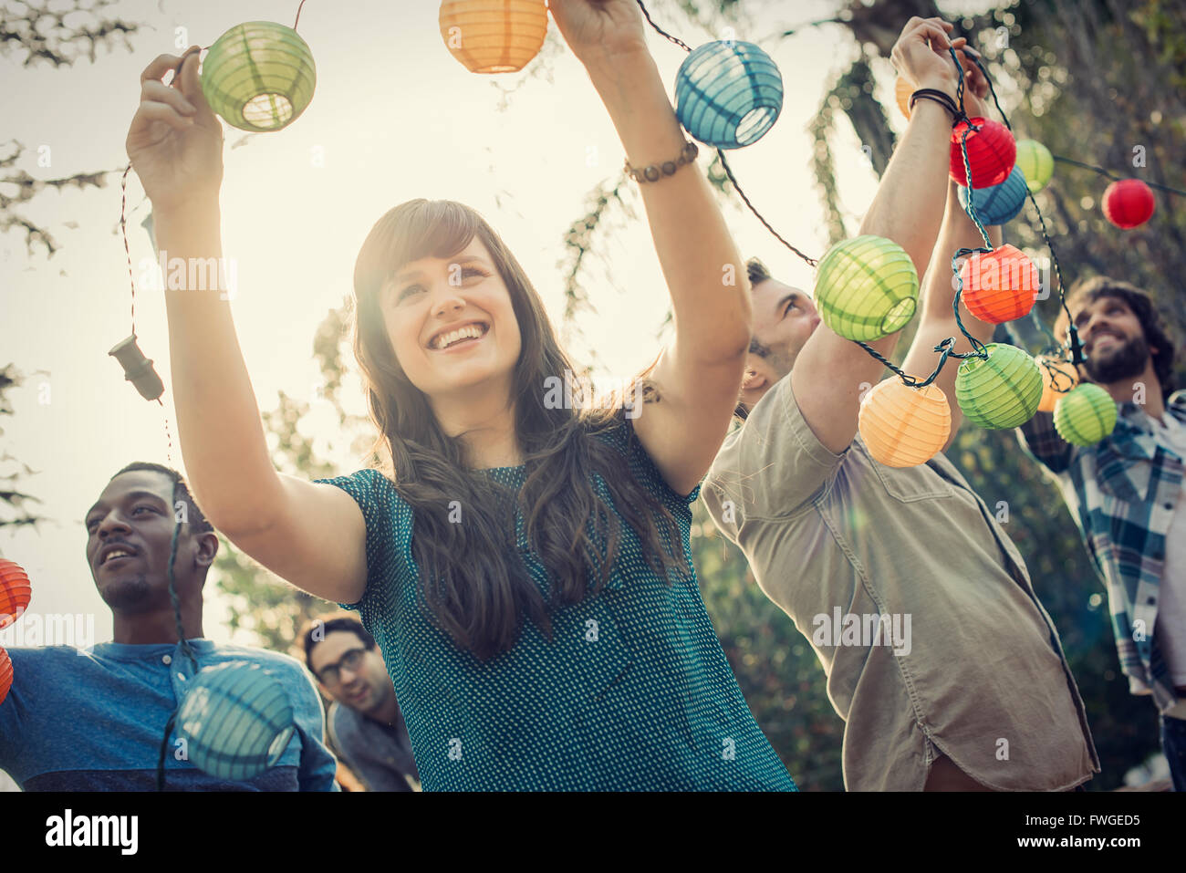 A group of men and women at a party dancing outdoors Stock Photo - Alamy