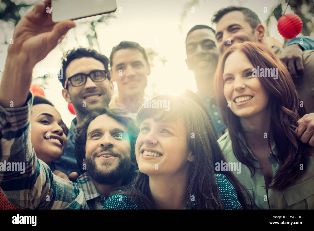 A group of friends gathering to take a group selfie Stock Photo - Alamy