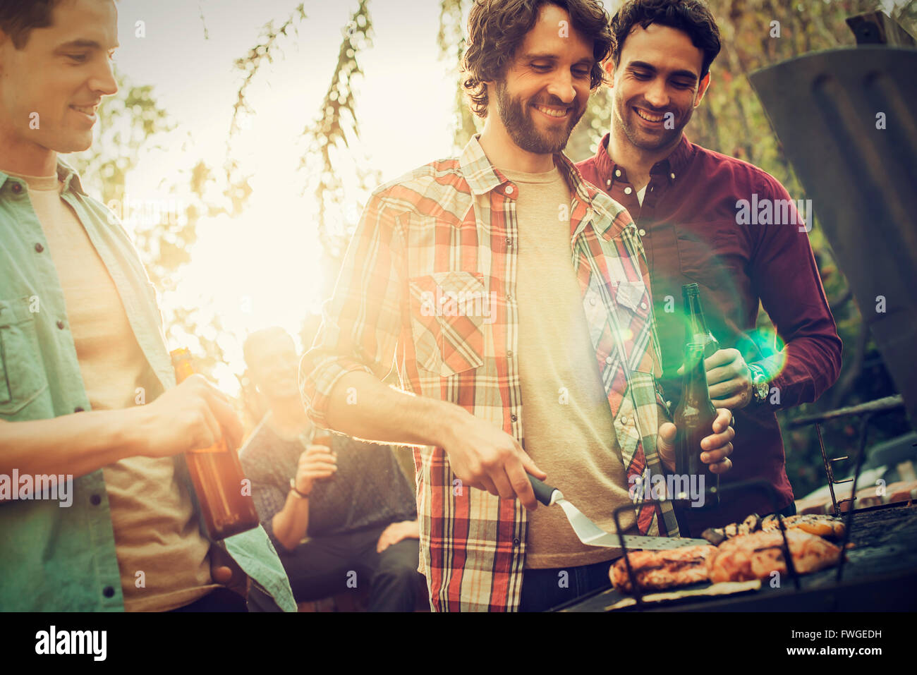 A group of friends at a summer evening barbeque Stock Photo - Alamy
