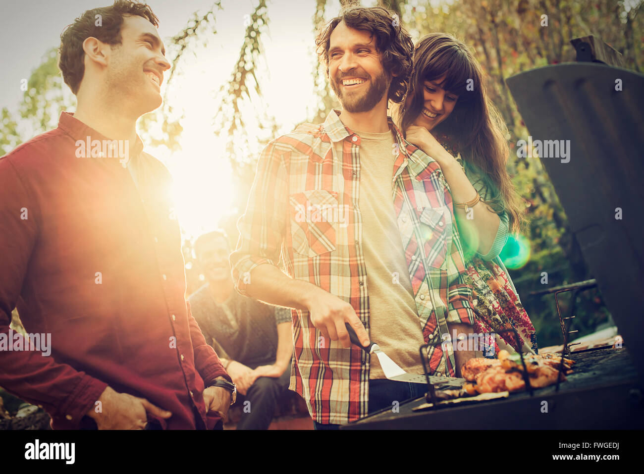 A group of friends at a summer evening barbeque Stock Photo - Alamy