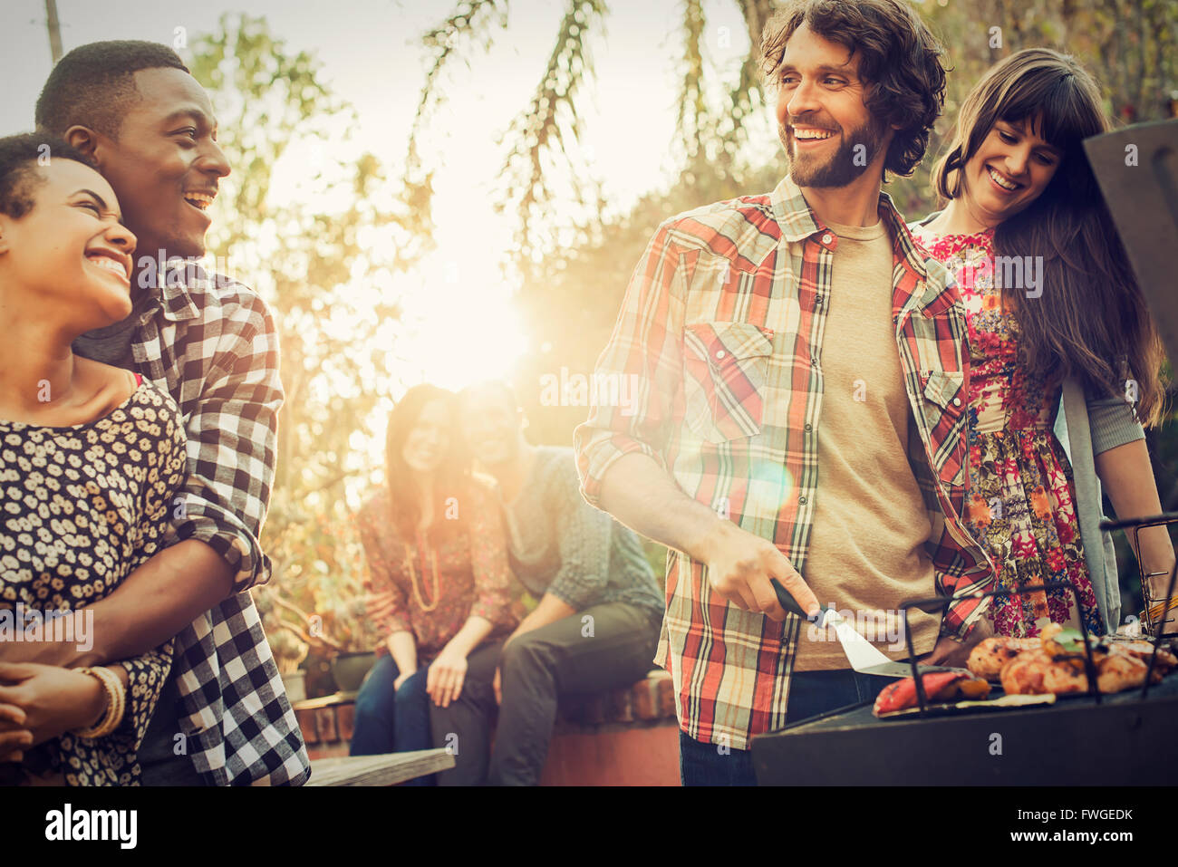 A group of friends at a summer evening barbeque Stock Photo - Alamy
