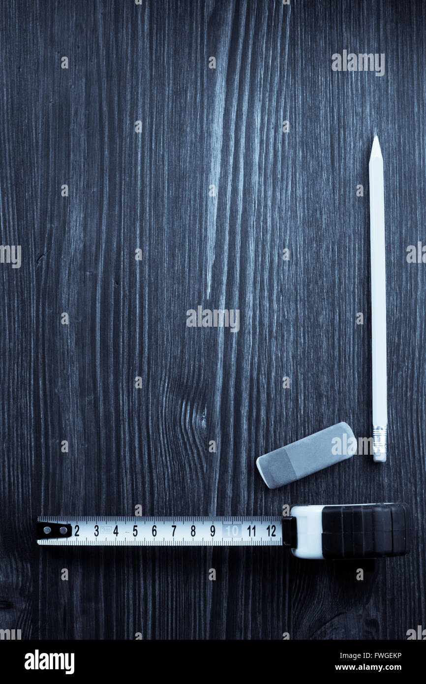 tape measure and pencil on wooden texture Stock Photo - Alamy