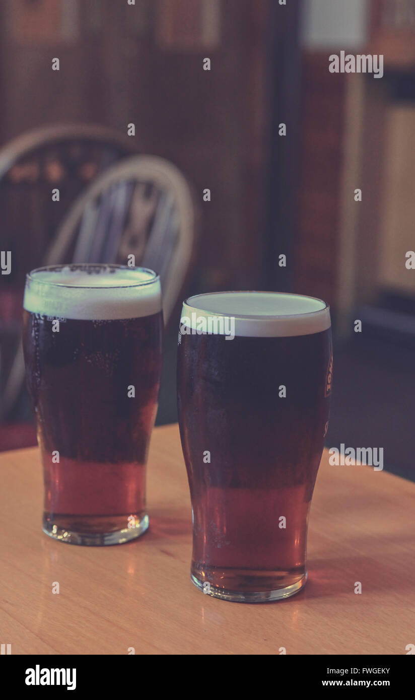 Two dark ales on a pub table Stock Photo - Alamy