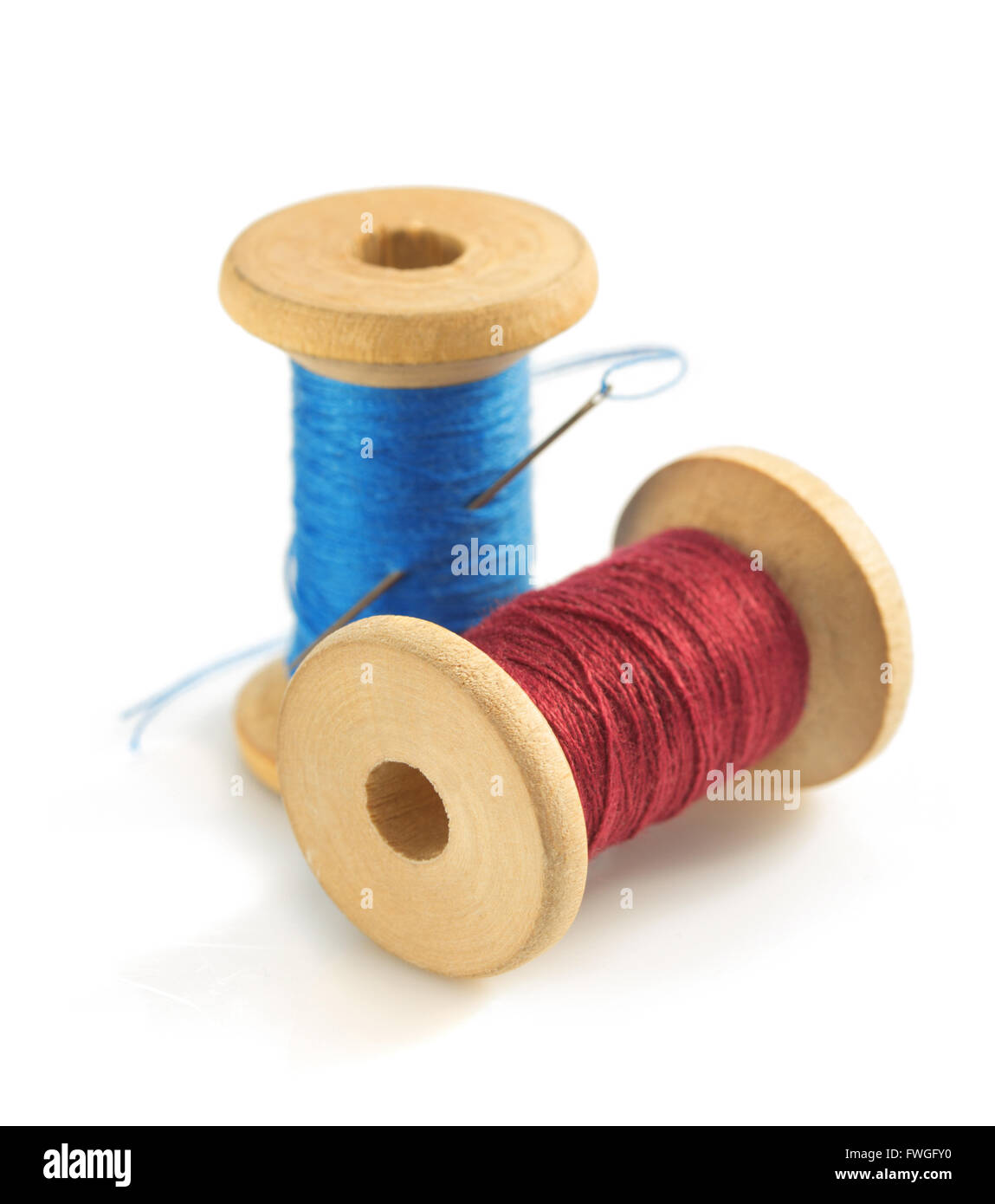 spool of thread and needle isolated on white background Stock Photo - Alamy