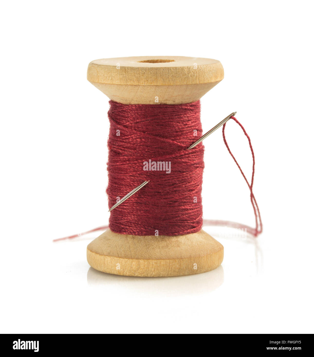 spool of thread and needle isolated on white background Stock Photo - Alamy