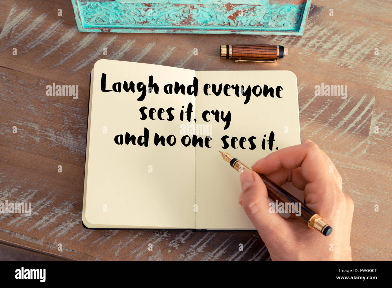 Retro effect and toned image of a woman hand writing on a notebook ...