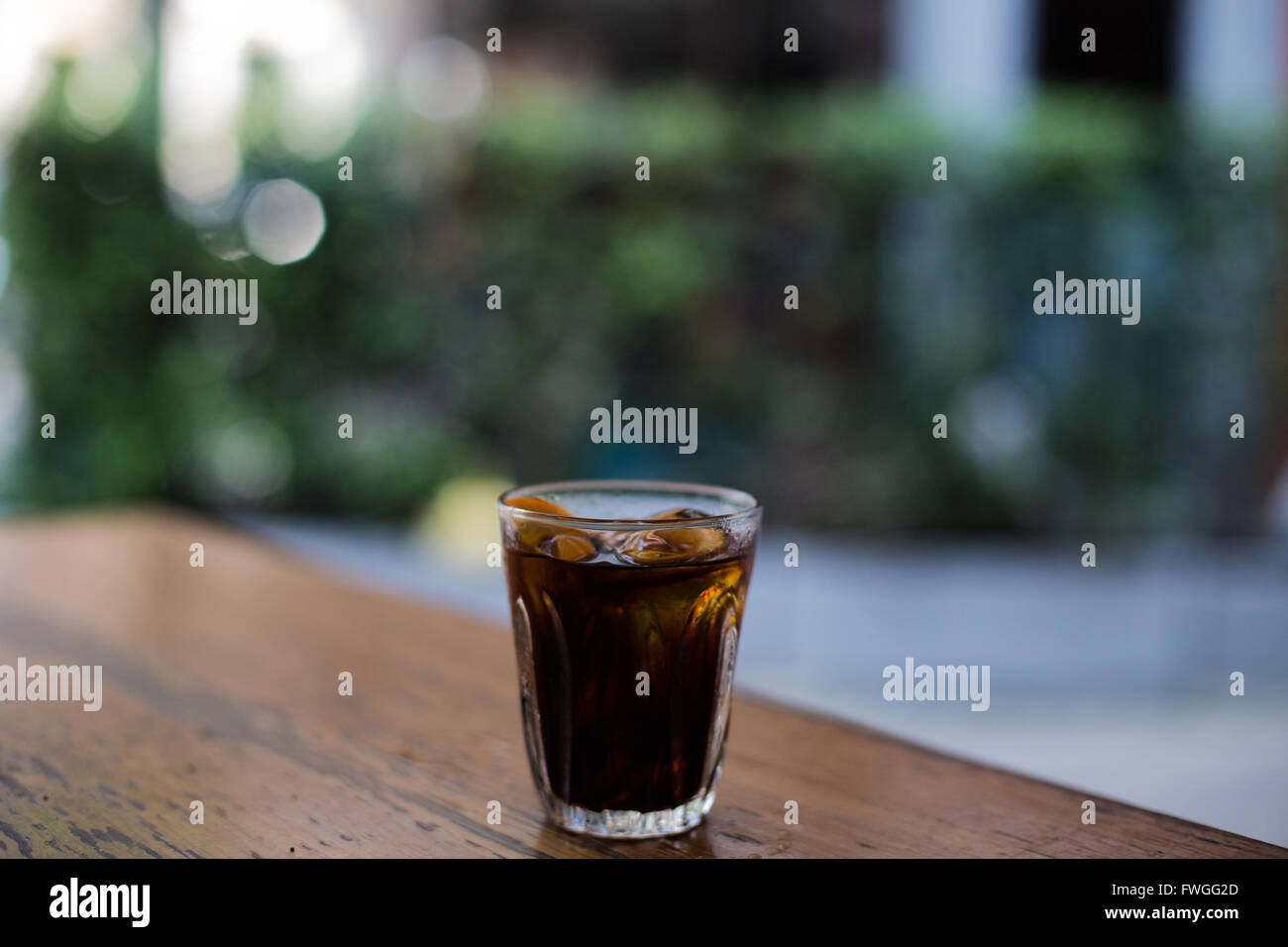 Cold brew iced coffee on wooden table with blurry background Stock ...