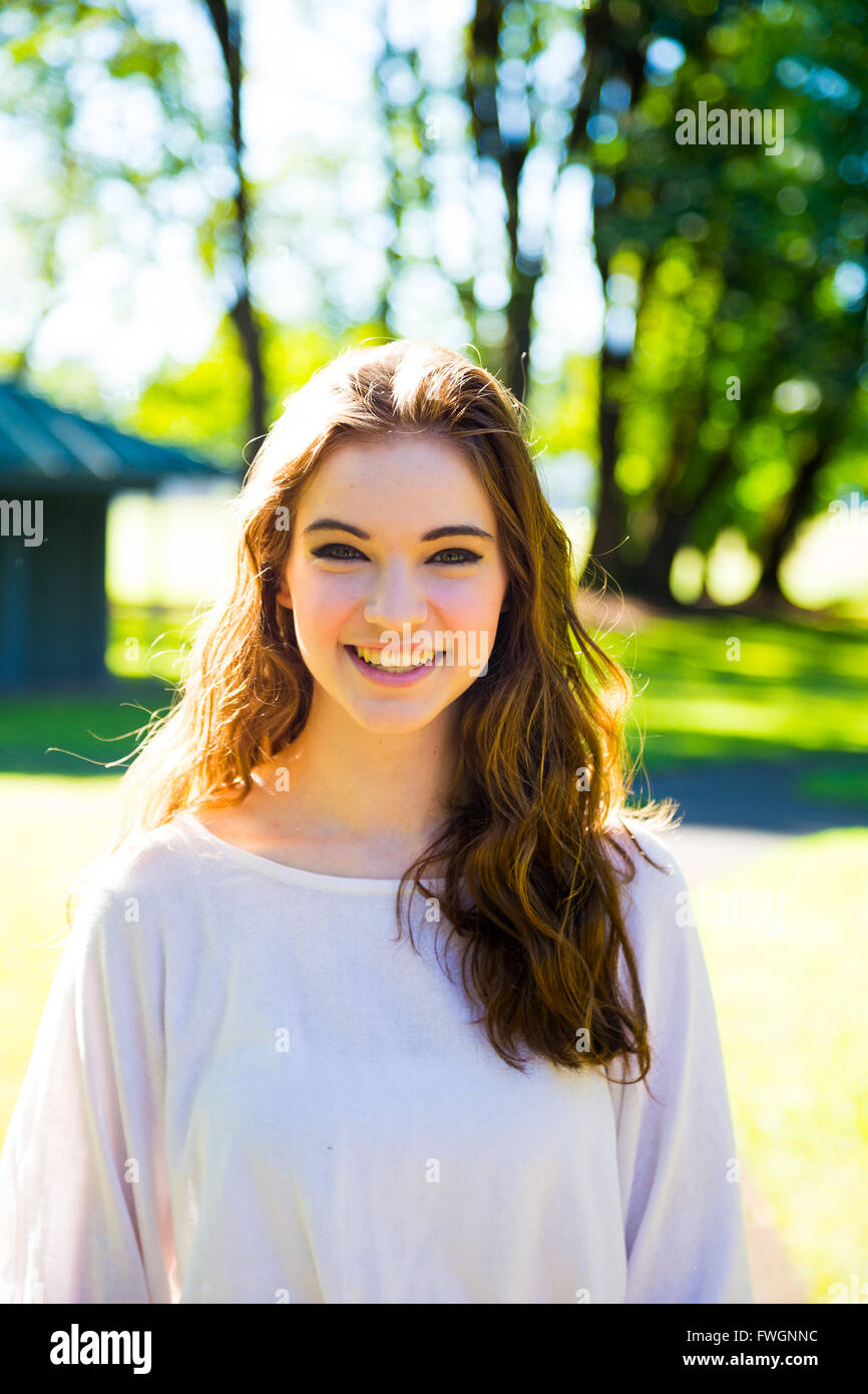 A beautiful young girl poses for a fashion style portrait outdoors at a ...