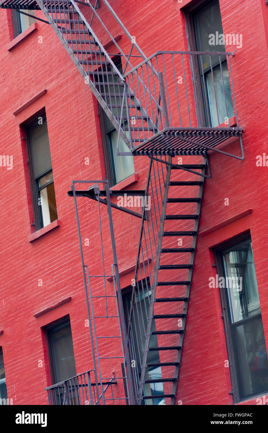 Red painted tenement block and fire escapes hi-res stock photography ...