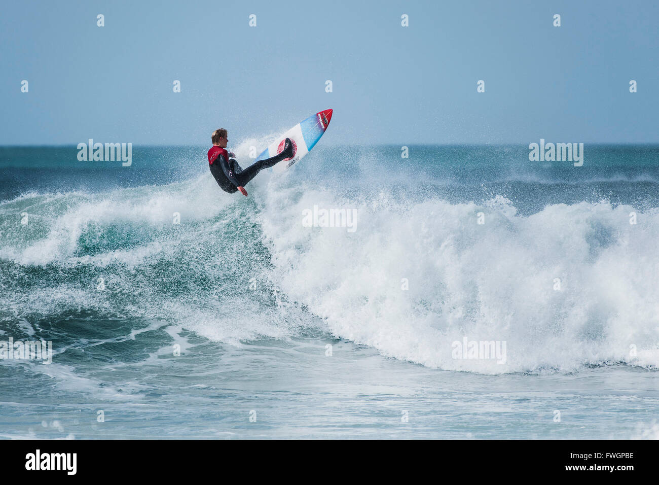 A surfer in spectacular action at Fistral in Newquay, Cornwall, England ...