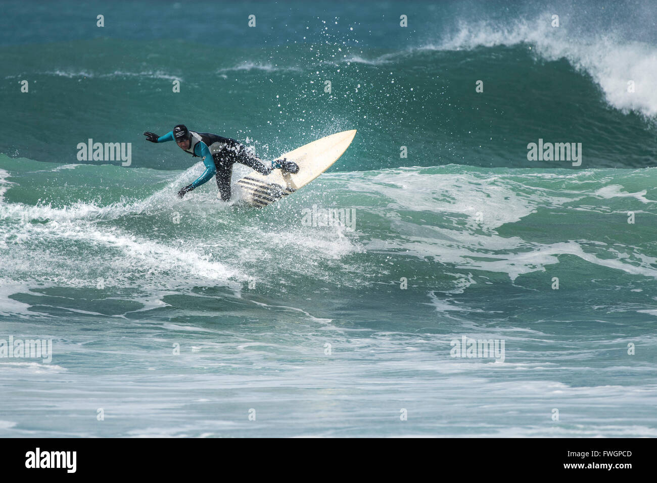 A surfer in spectacular action at Fistral in Newquay, Cornwall, England ...