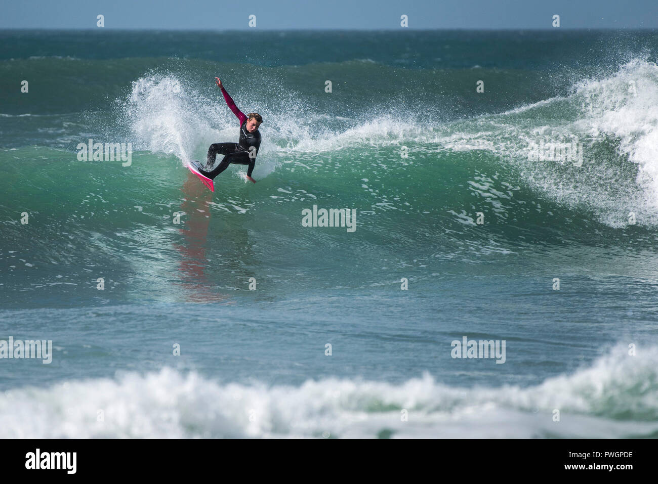 A surfer in spectacular action at Fistral in Newquay, Cornwall, England ...