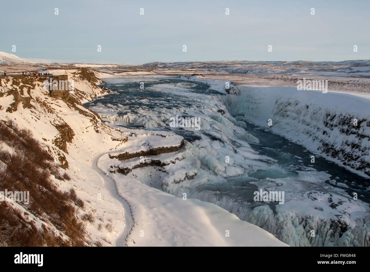 Gulfloss waterfalls surrounded by snow, view looking up river in winter ...
