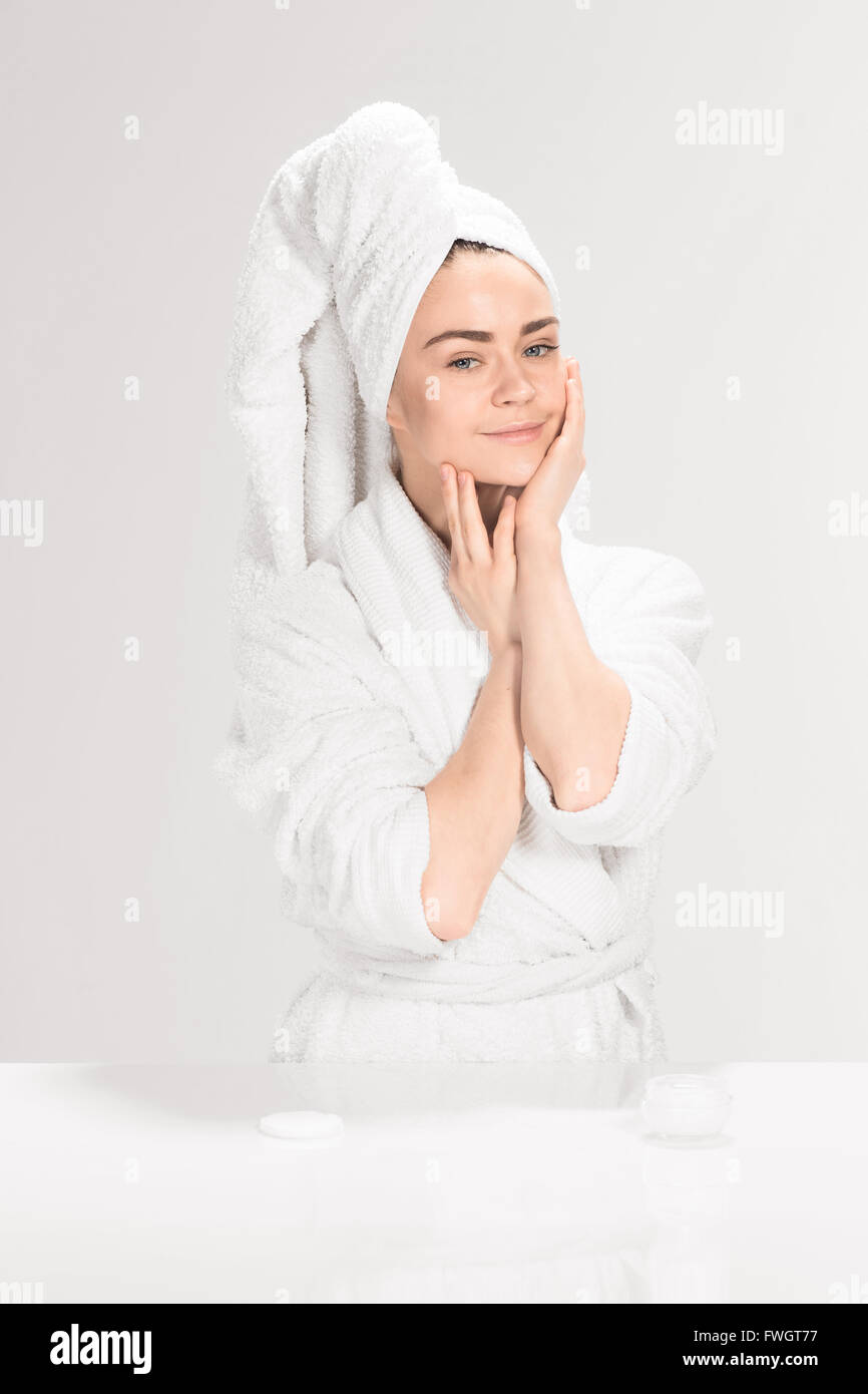 Woman cleaning face in bathroom Stock Photo - Alamy