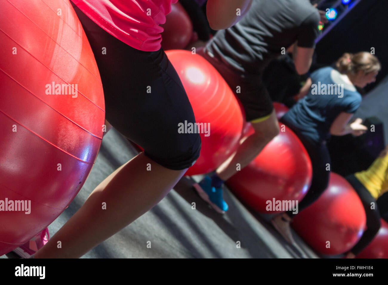 Closeup of Girl doing Fitness Activity Sitting on Big Red Ball in Gym ...