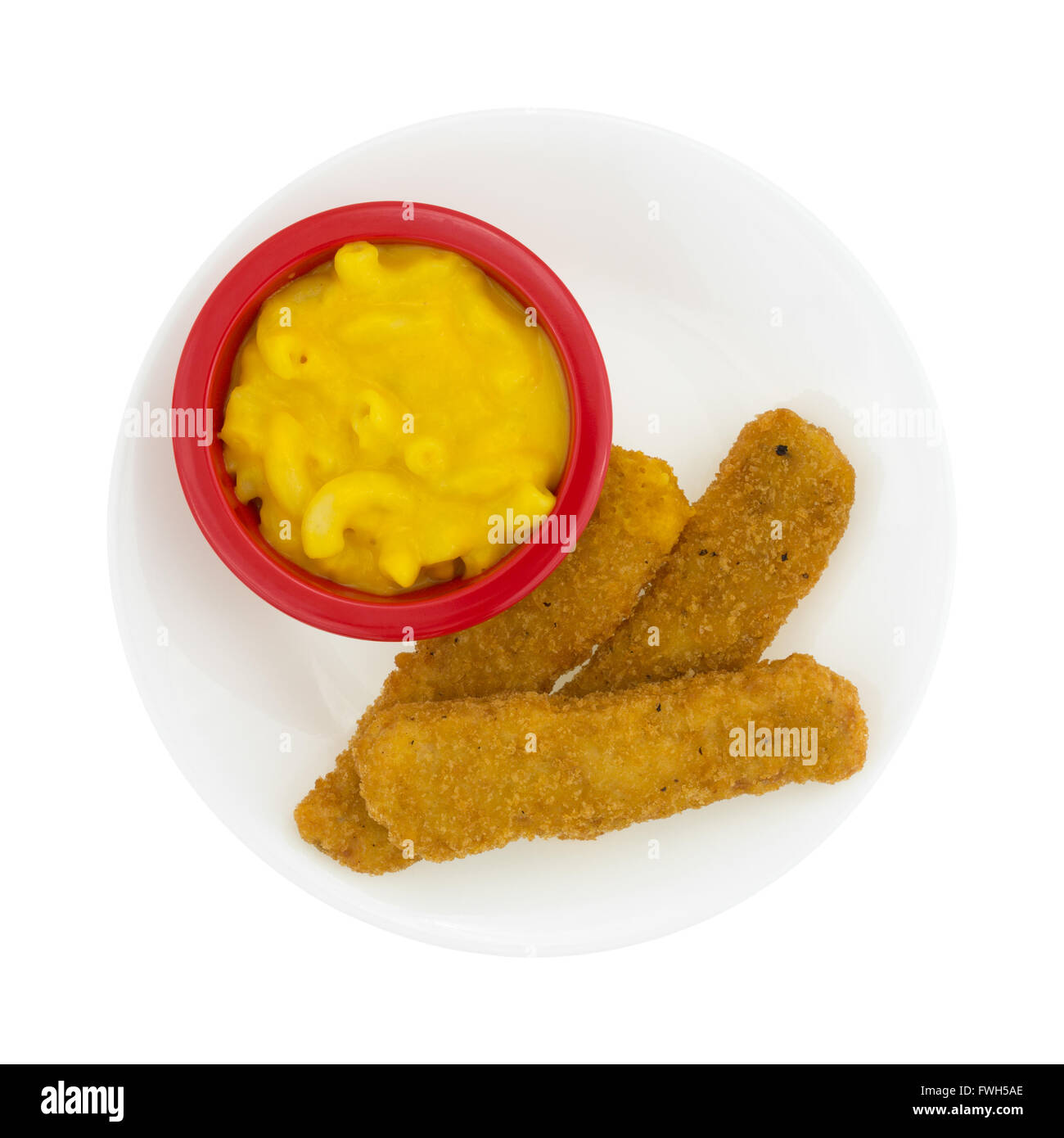 Top view of a chicken fingers meal with macaroni and cheese on a plate ...