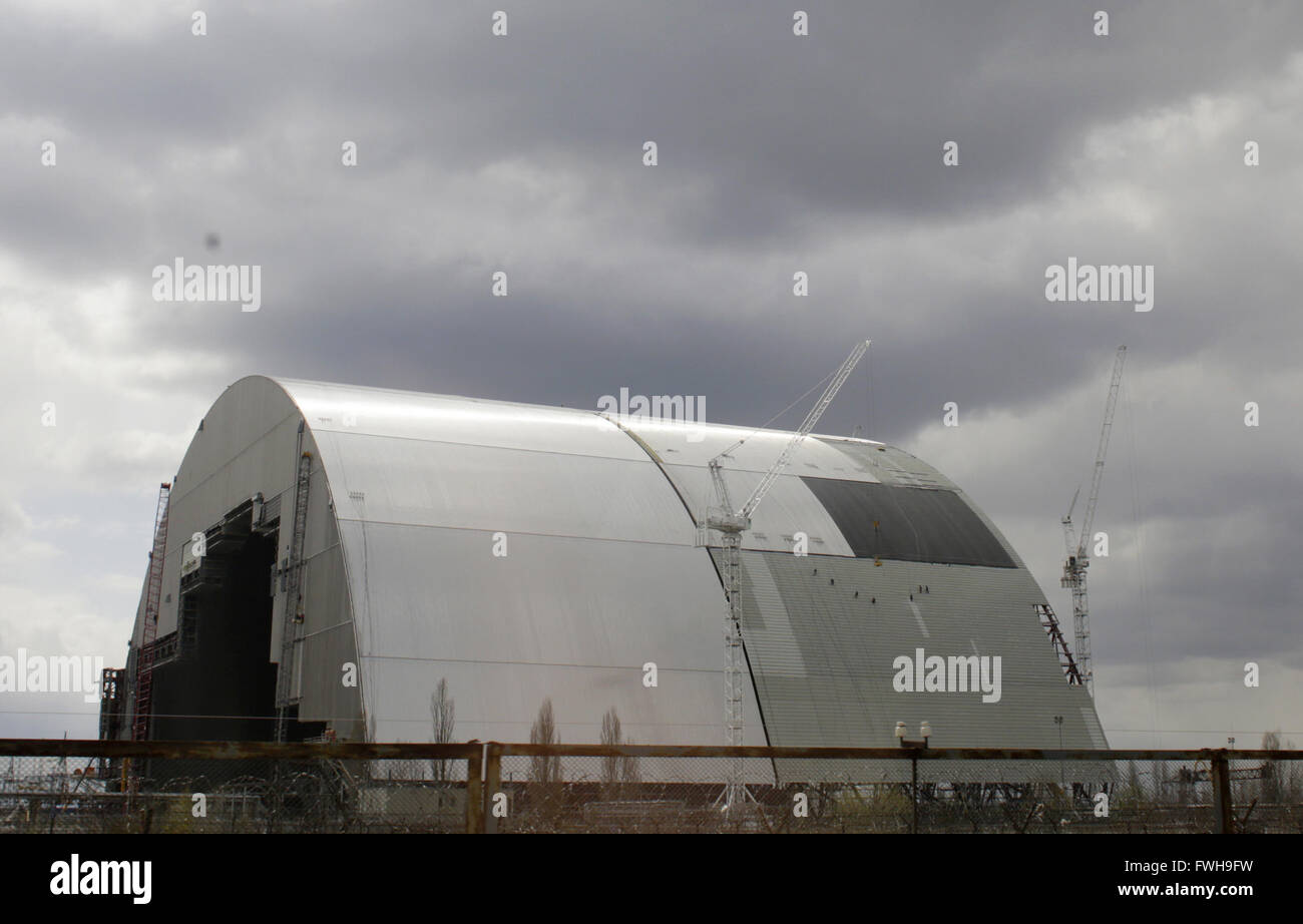 April 21, 2015 - Workers walk by a shelter and containment area built ...