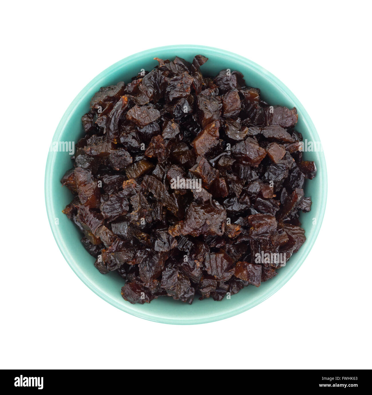 Top view of a portion of diced prunes in a bowl isolated on a white ...