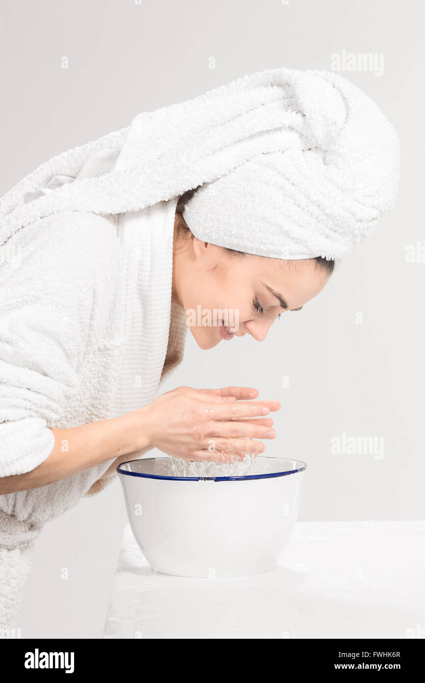 Young woman washing face with clean water Stock Photo - Alamy