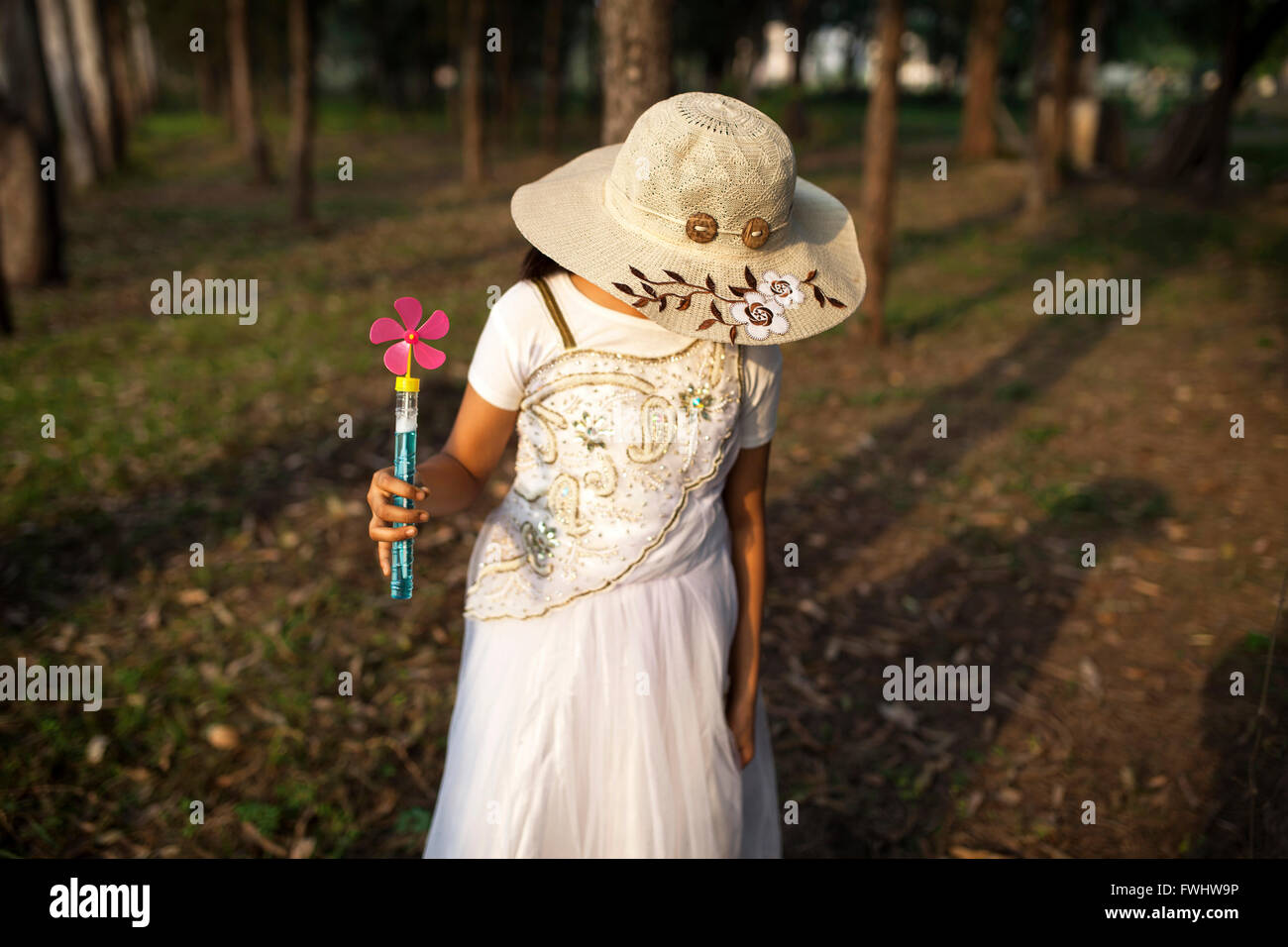 Indian teenage girl wearing white hat and gown Stock Photo - Alamy