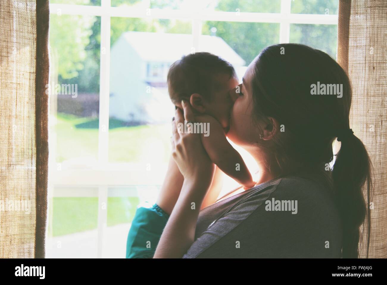 Side View Of Mother And Baby At Home Stock Photo - Alamy