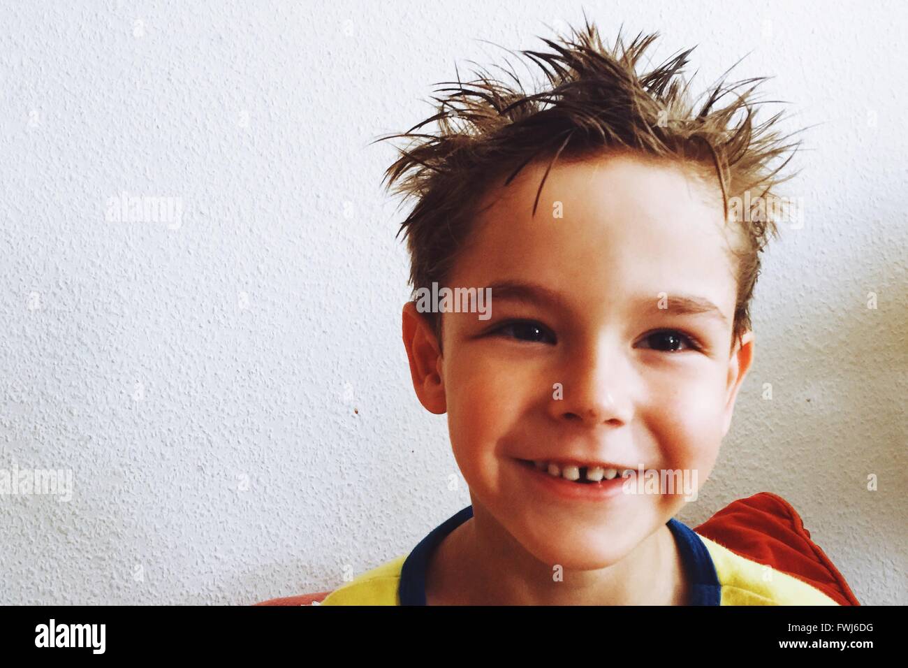 Boy standing up against wall hi-res stock photography and images - Alamy