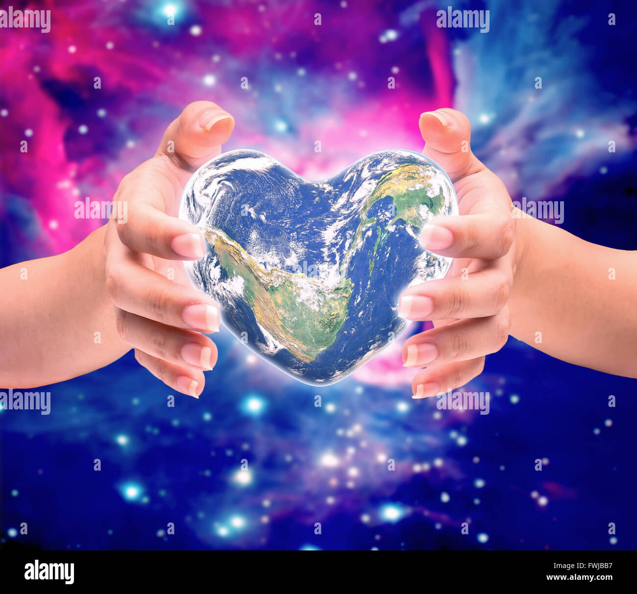 World in heart shape with over women human hands on blurred natural ...