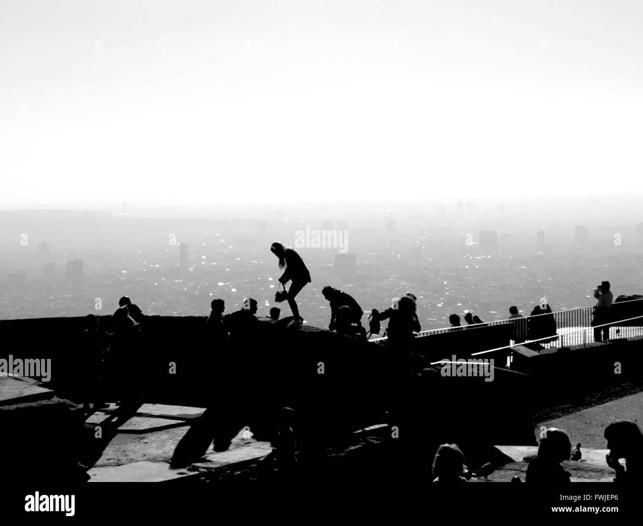 People Climbing Over Retaining Wall Against Clear Sky Stock Photo - Alamy