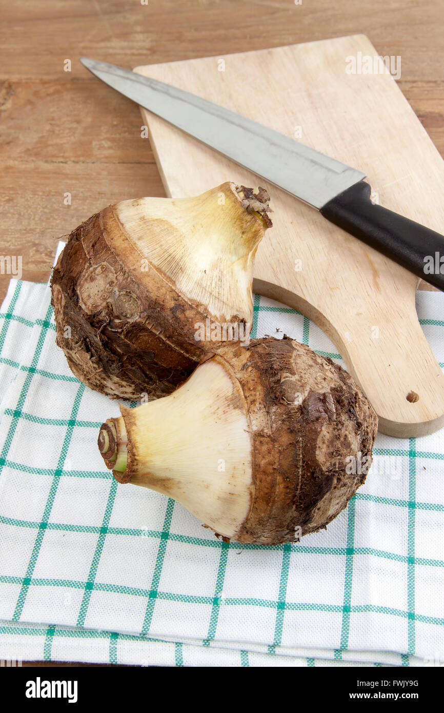 Head two taro on white cotton and wood table Stock Photo - Alamy