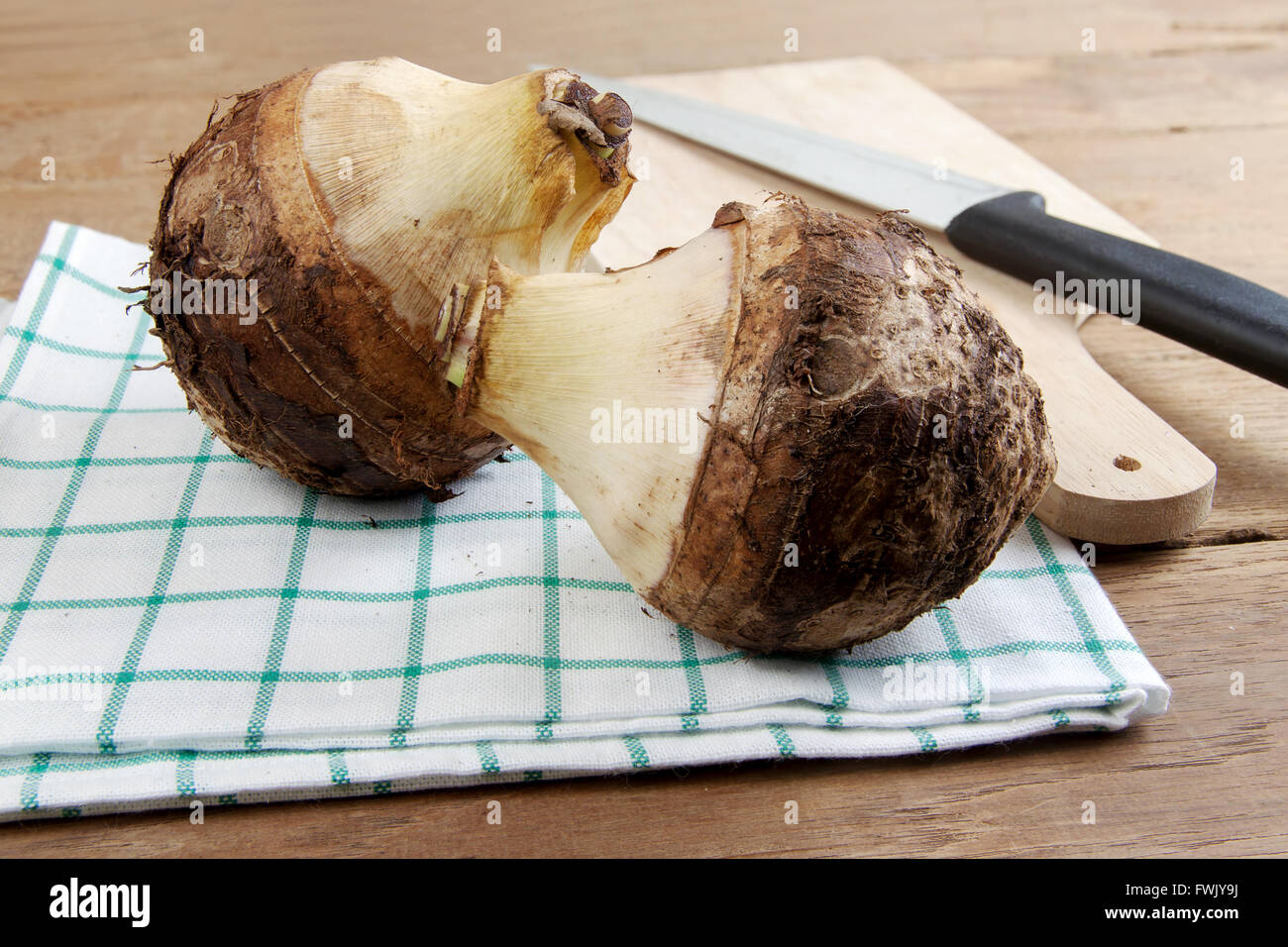 Head two taro on white cotton and wood table Stock Photo - Alamy