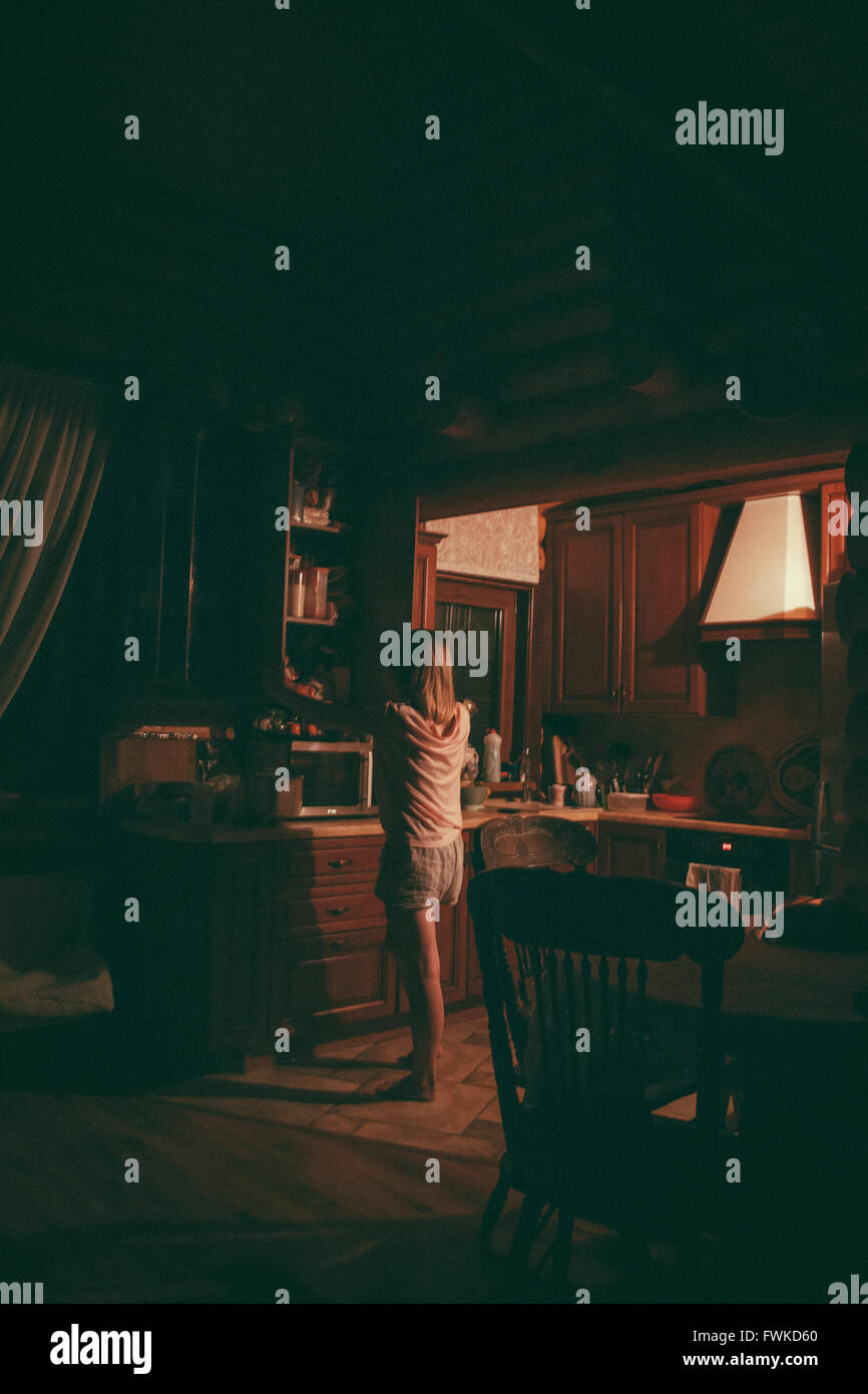 Woman searching cupboard hi-res stock photography and images - Alamy