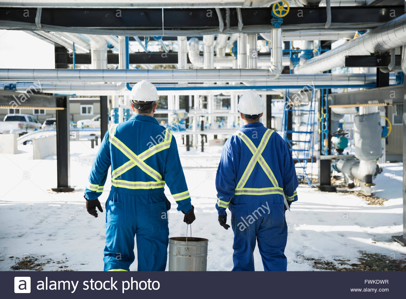 Worker carrying pipe hi-res stock photography and images - Alamy