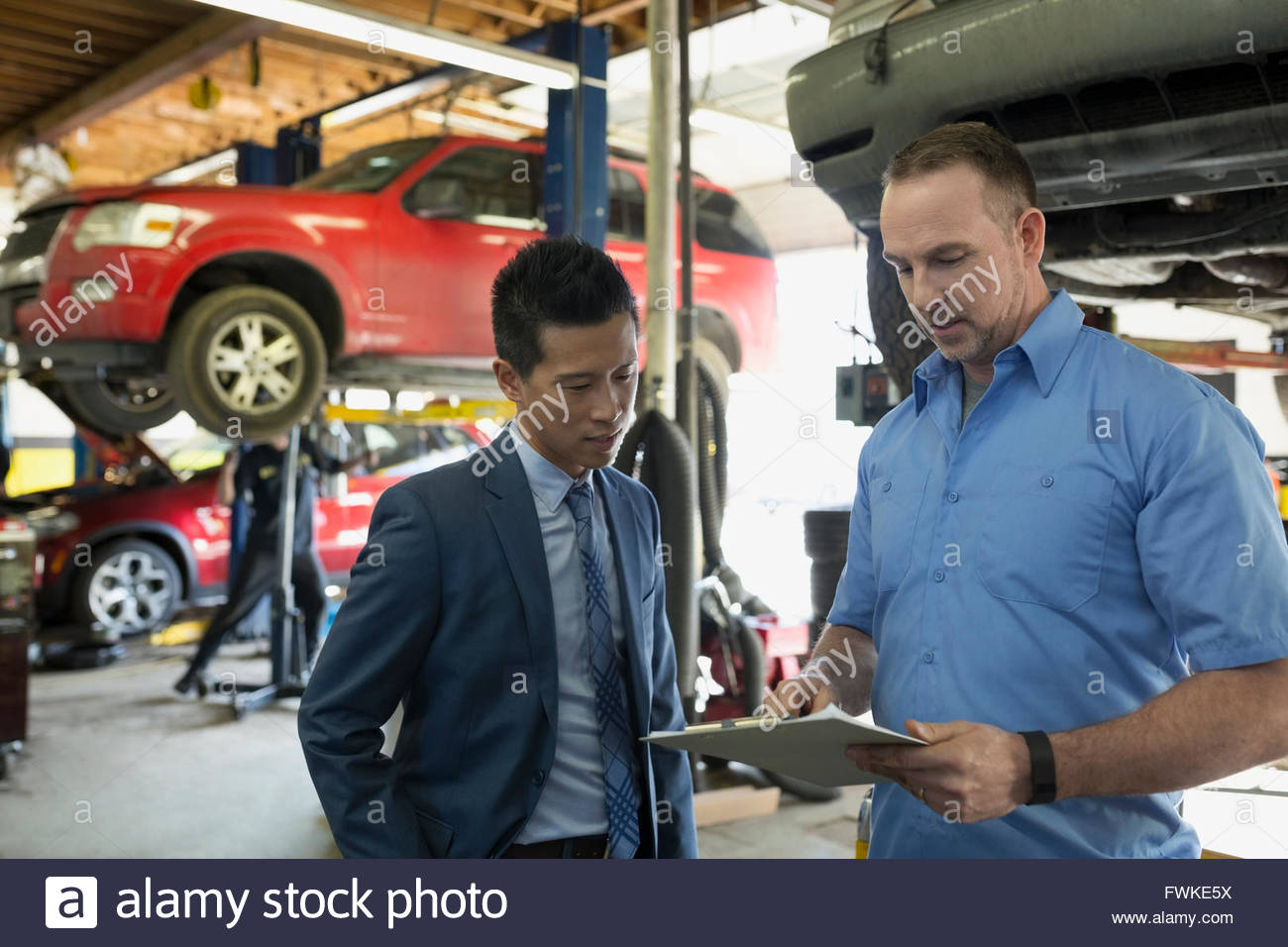 Customer standing with mechanic by car hi-res stock photography and ...