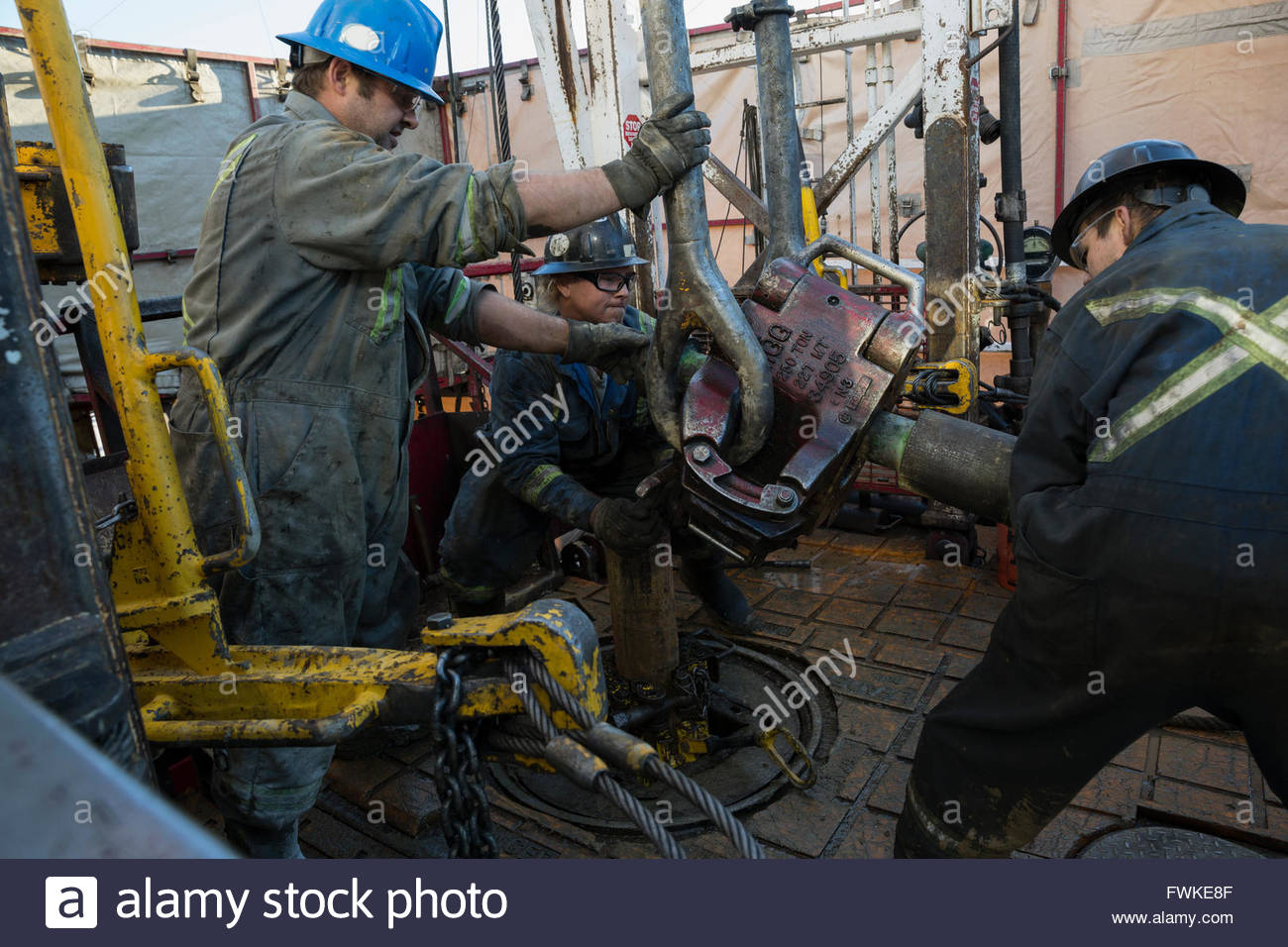 Three young oil rig workers hi-res stock photography and images - Alamy