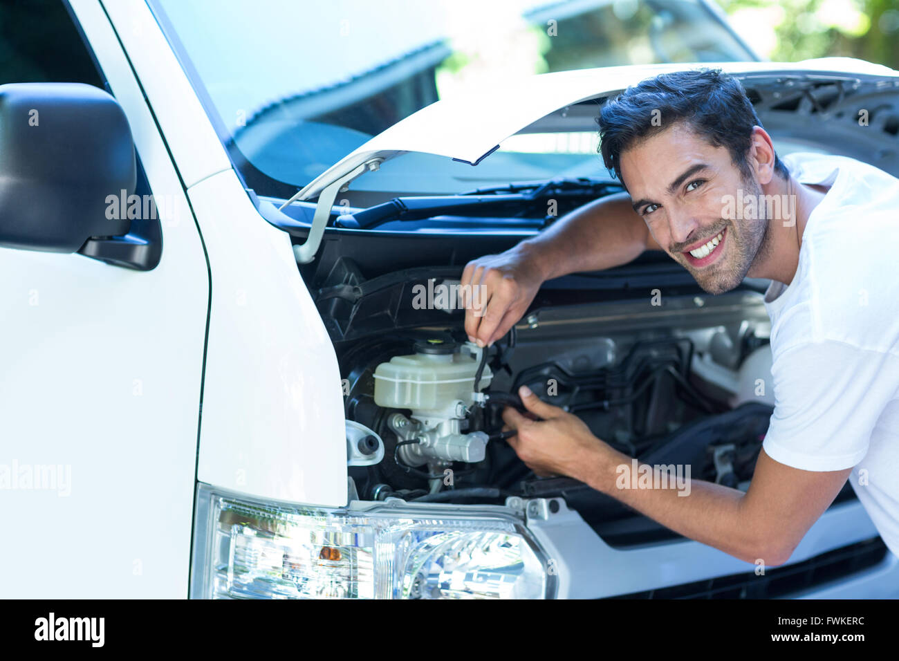 Portrait of happy mechanic fixing van Stock Photo - Alamy