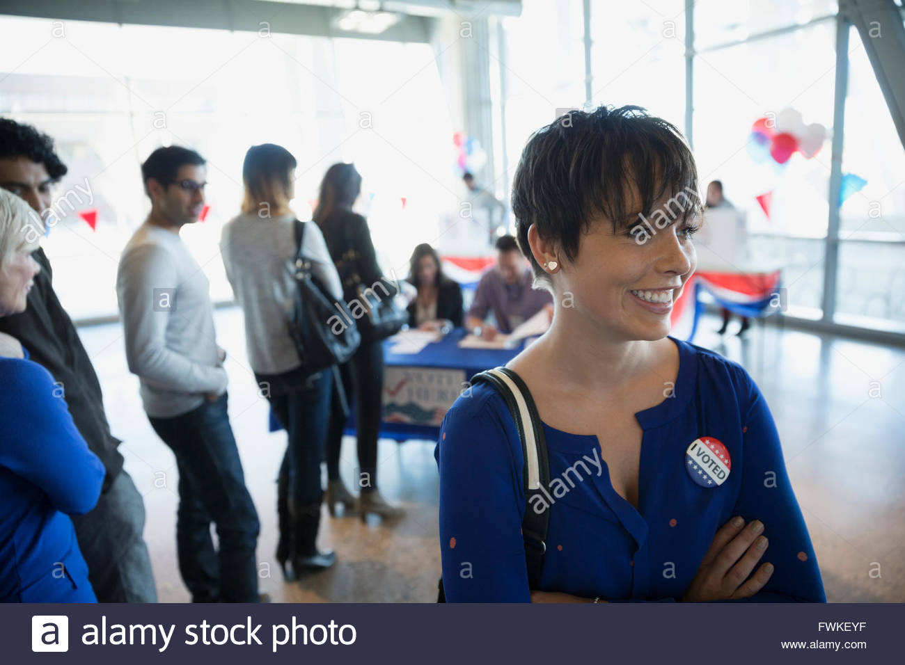 Smiling young woman at voter polling place Stock Photo - Alamy