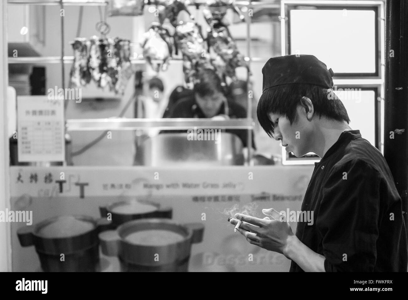 A chef at a Chinatown Chinese restaurant taking a break Stock Photo - Alamy