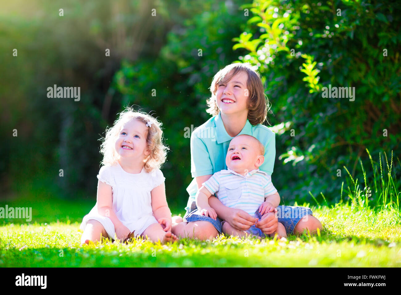 Three happy kids, brothers and sister, laughing teenager boy, little ...