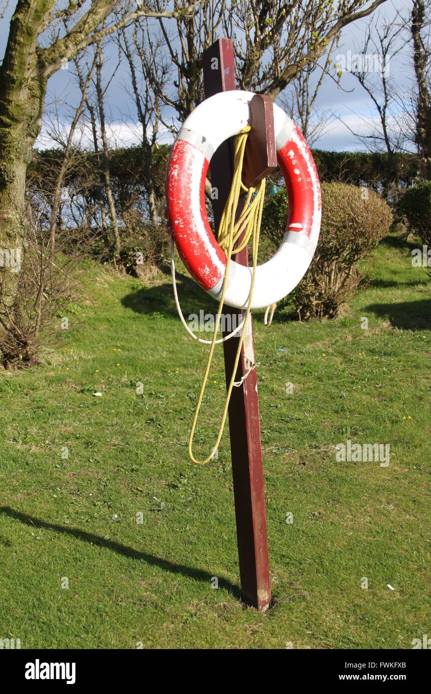 Old weathered life preserver, life buoy or life ring and rope on a ...