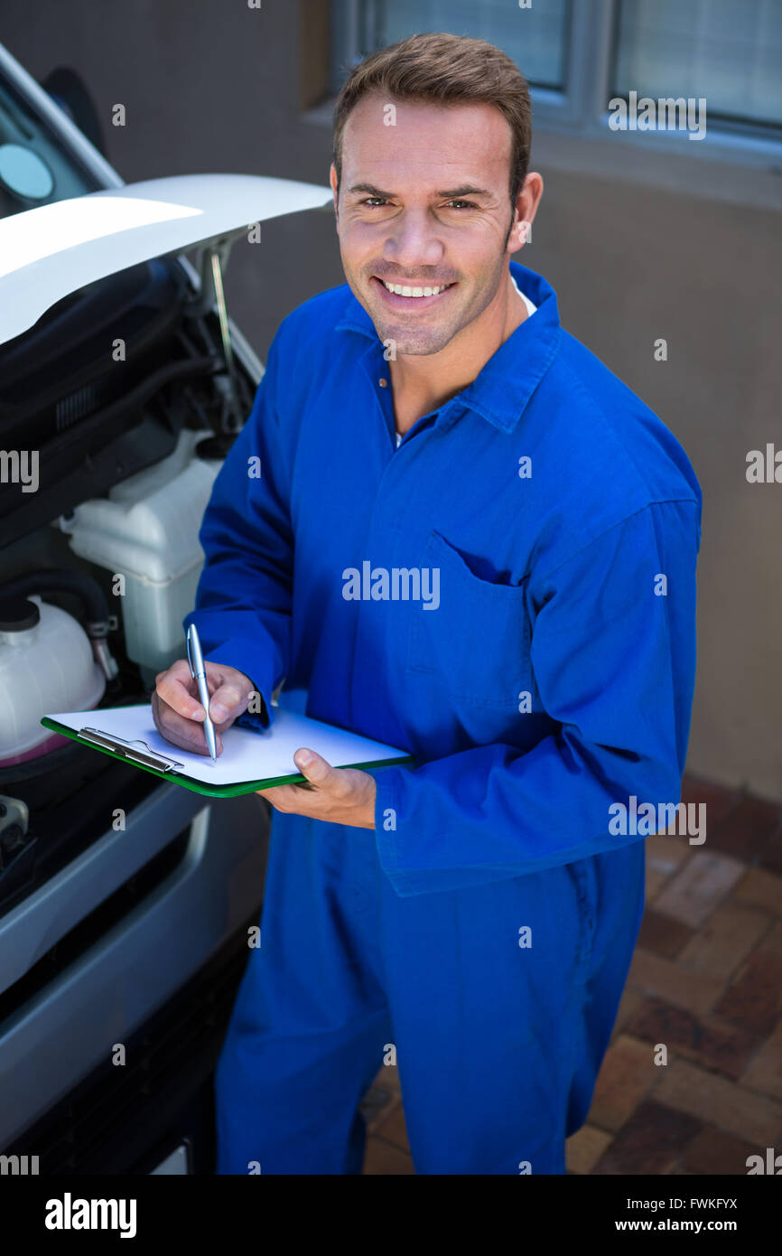 Mechanic preparing a check list Stock Photo - Alamy