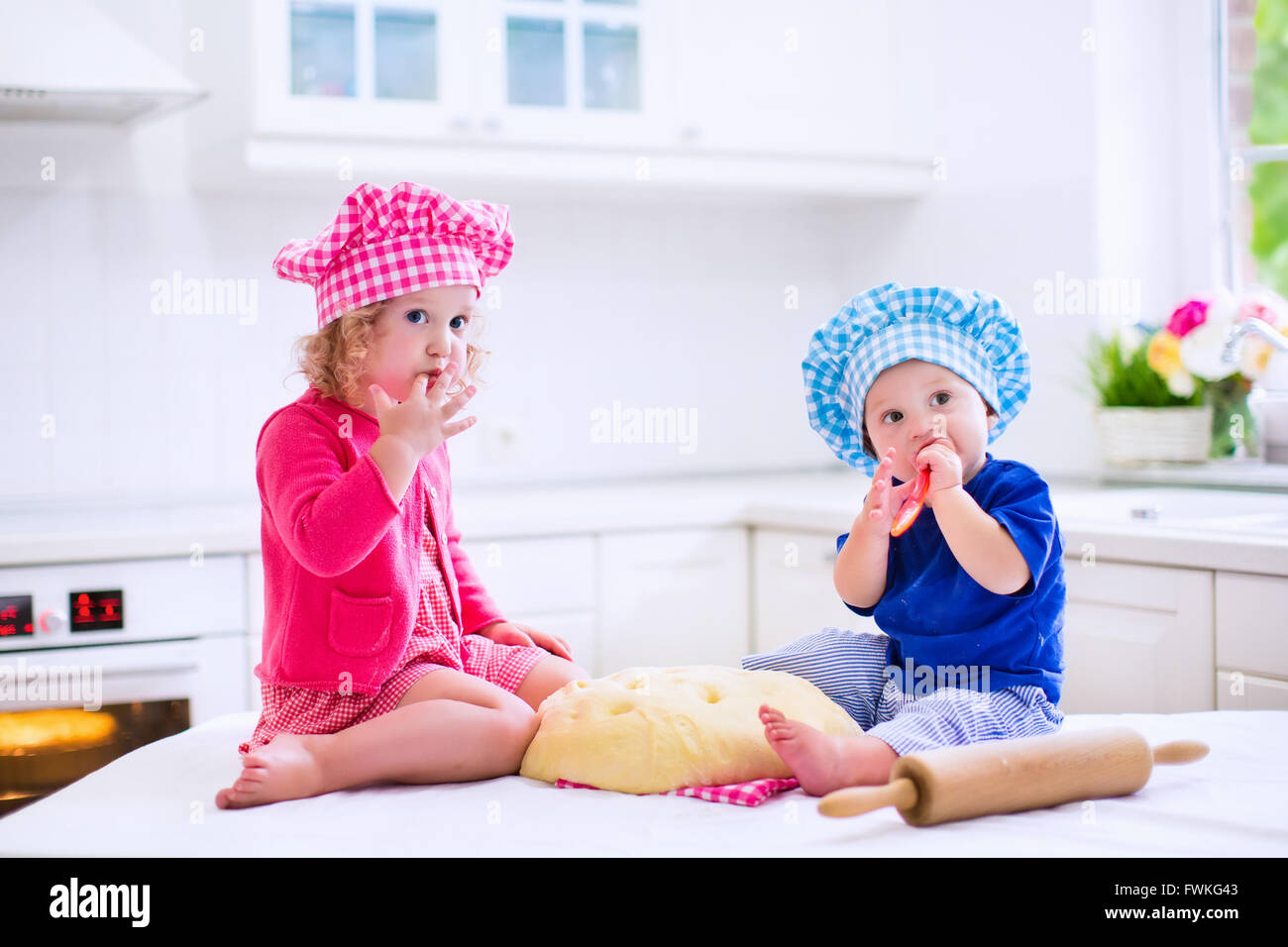 Kids baking. Two children cooking. Little girl and baby boy cook and ...