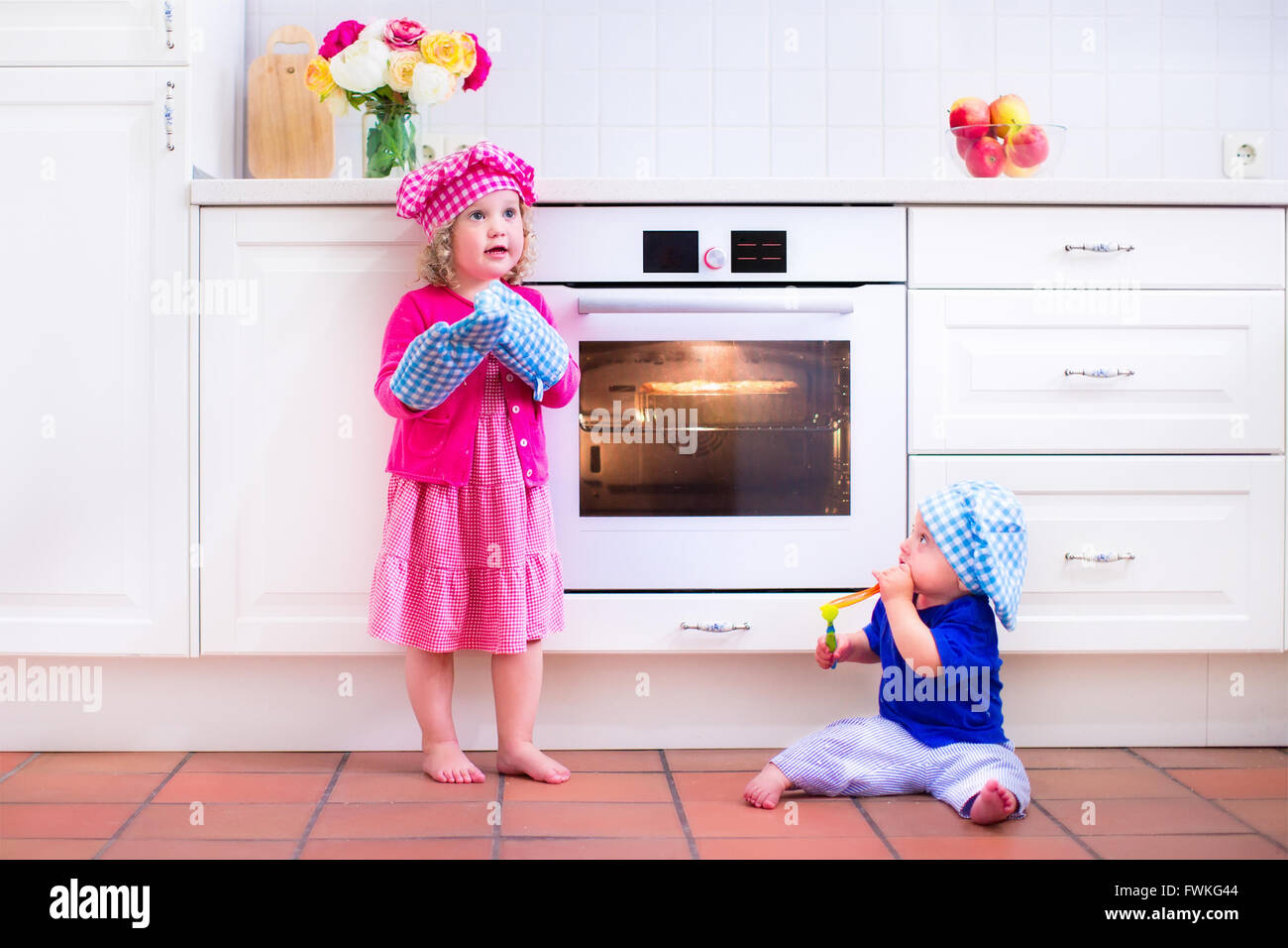 Kids baking. Two children cooking. Little girl and baby boy cook and ...