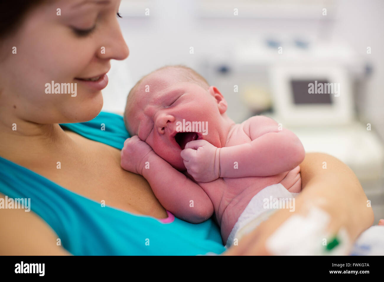 Mother giving birth to a baby. Newborn baby in delivery room. Mom ...